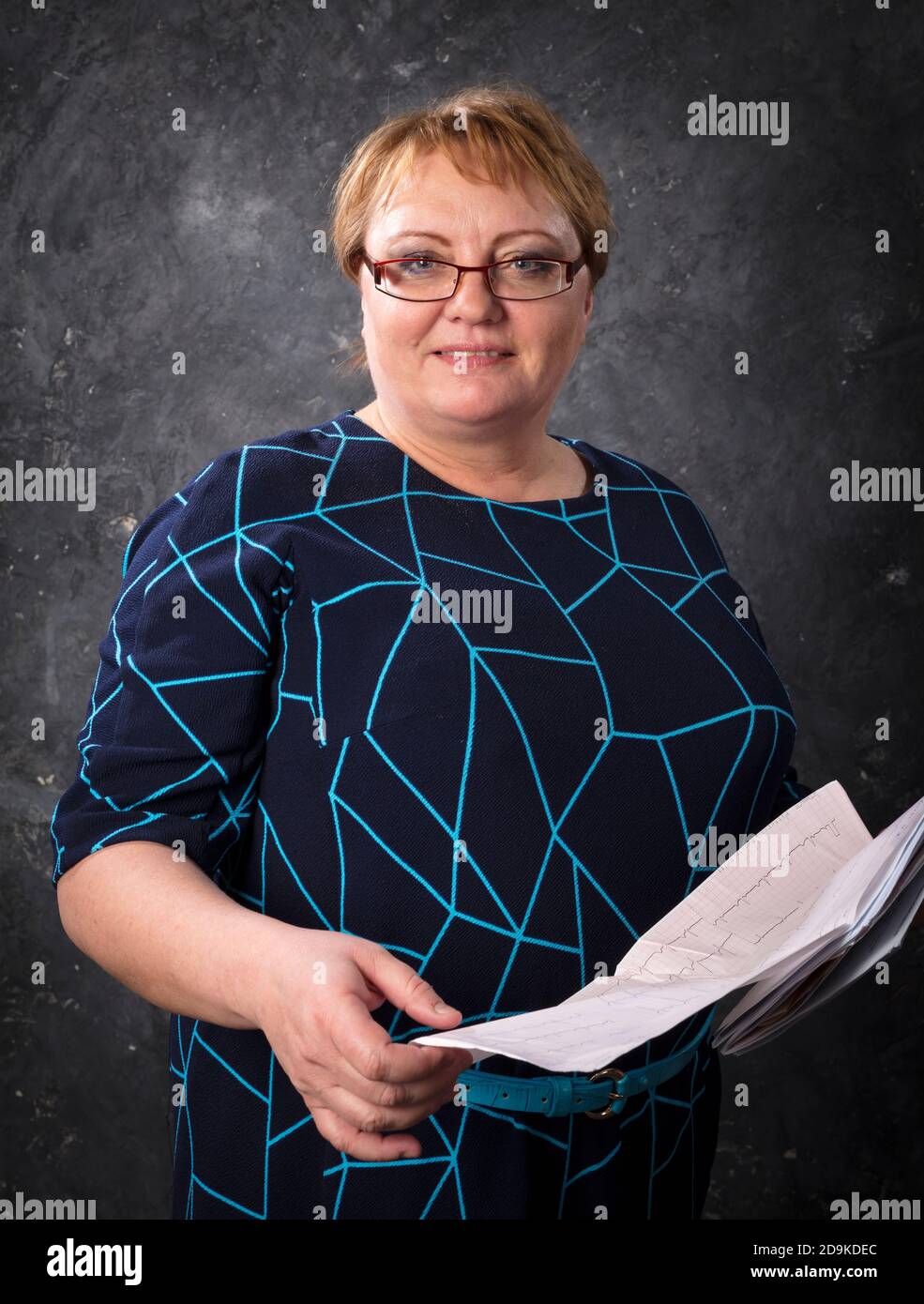 Middle aged woman accountant with papers studio portrait Stock Photo ...