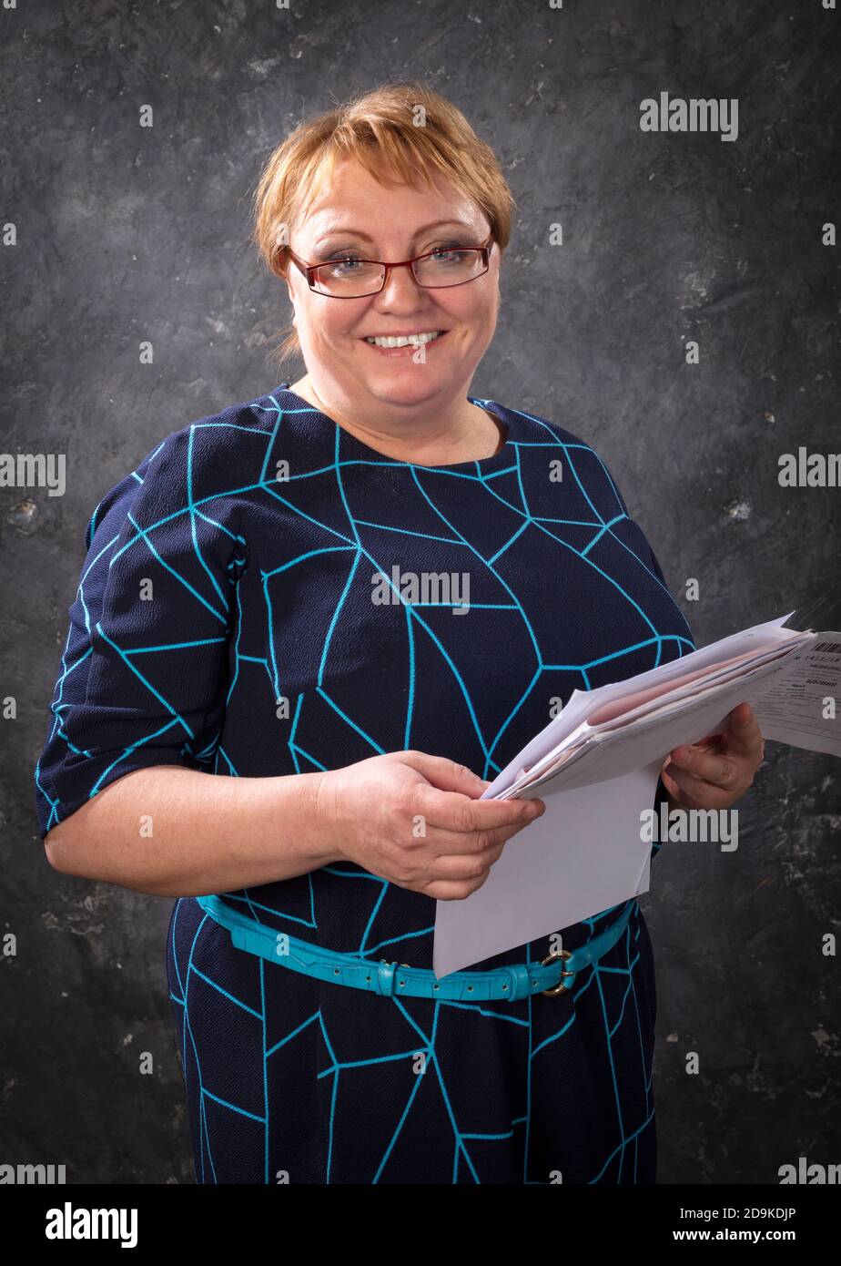 Middle aged woman accountant with papers studio portrait Stock Photo ...