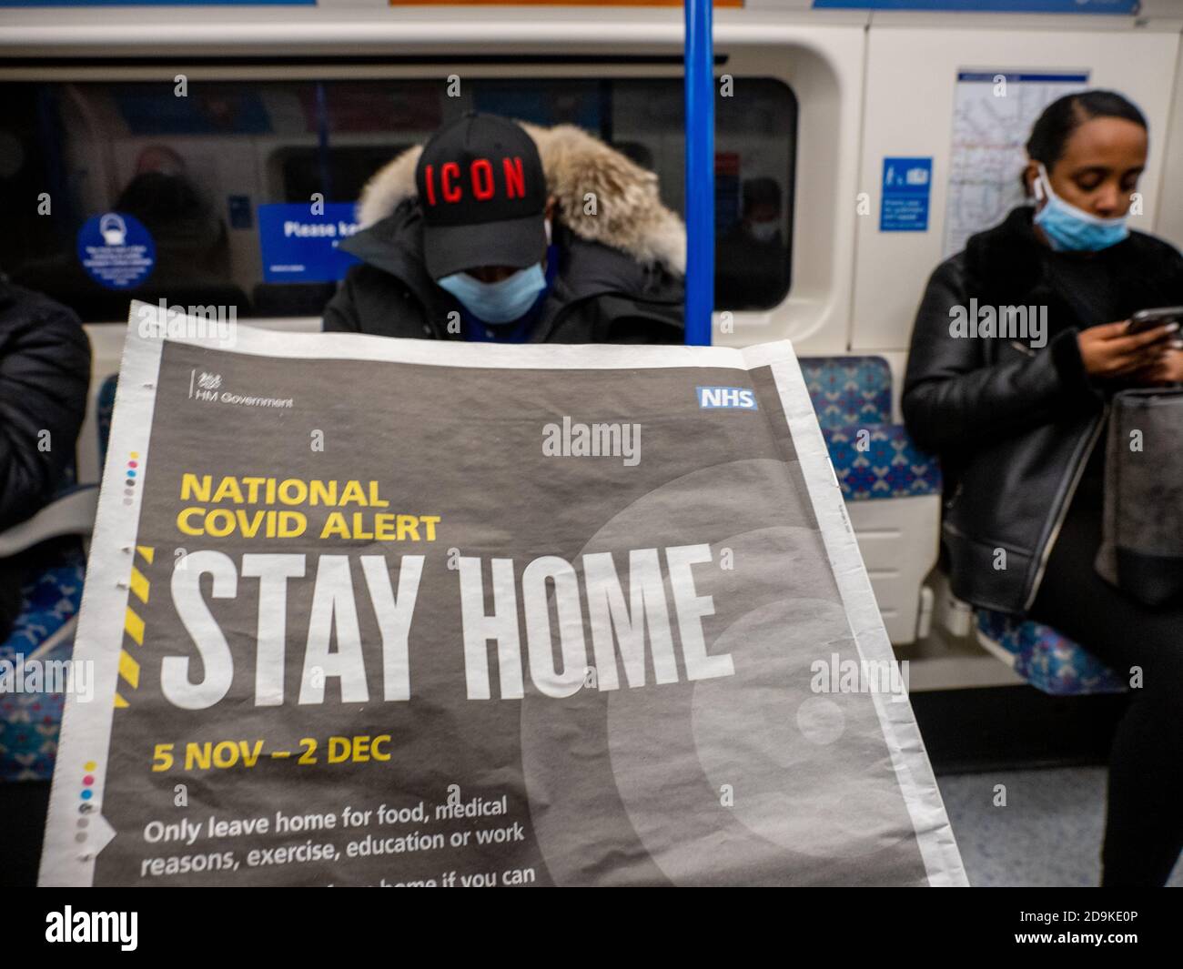 STAY HOME: government advice in a newspaper on a tube train during ...