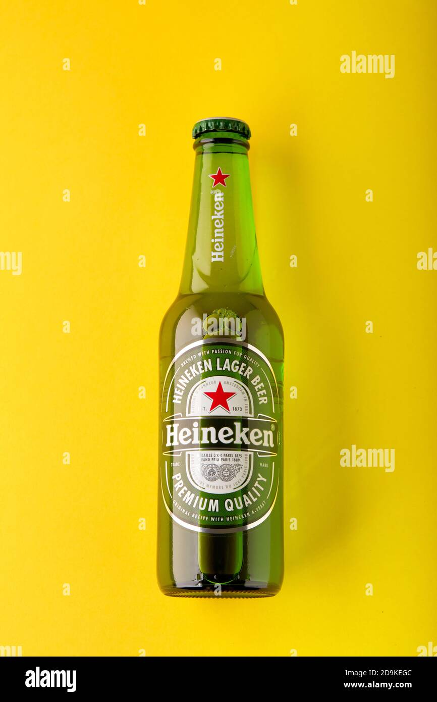 Bottle of Heineken Lager Beer on yellow background. Heineken is the ...