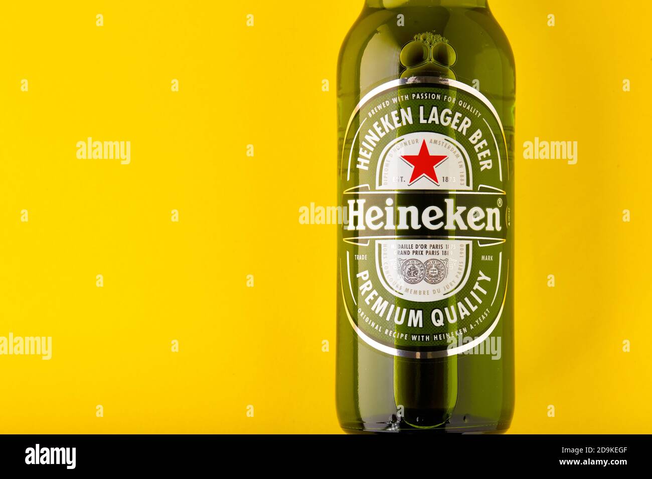 Bottle of Heineken Lager Beer on yellow background. Heineken is the ...