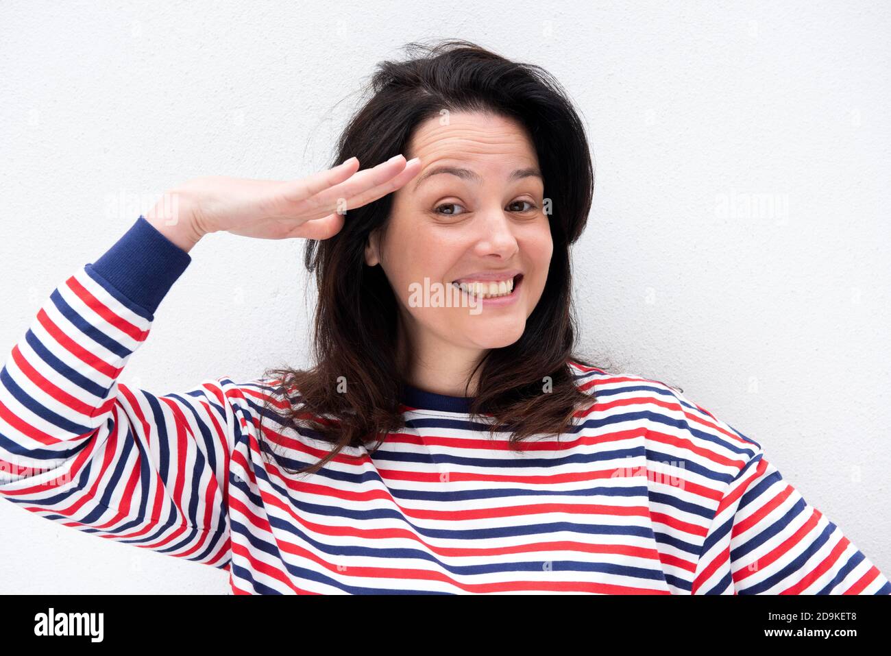 Close up portrait young woman saluting by isolated white background ...