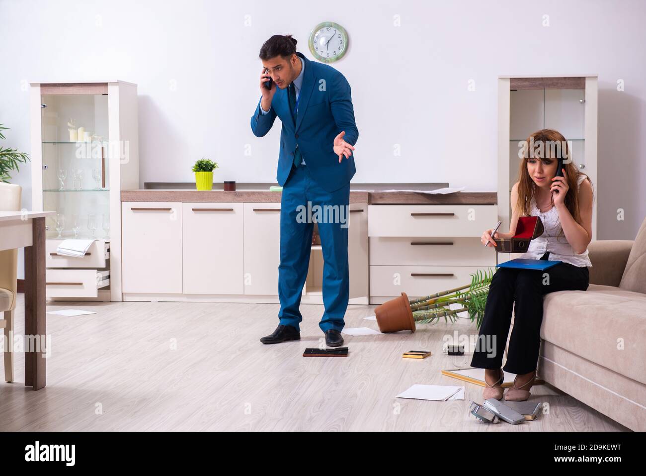 Female owner and police officer in housebreaking concept Stock Photo ...