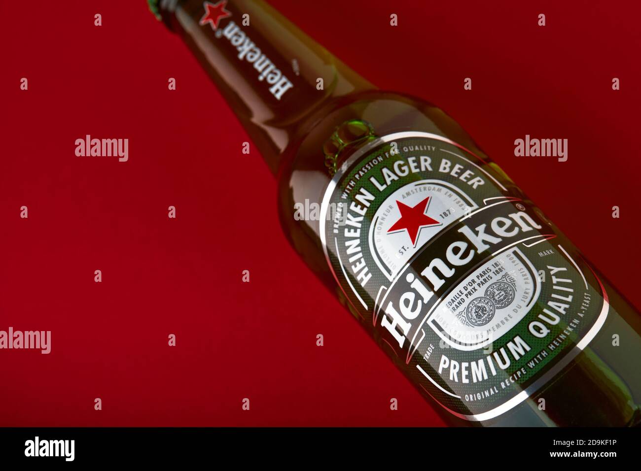 Bottle of Heineken Lager Beer on red background. Heineken is the ...