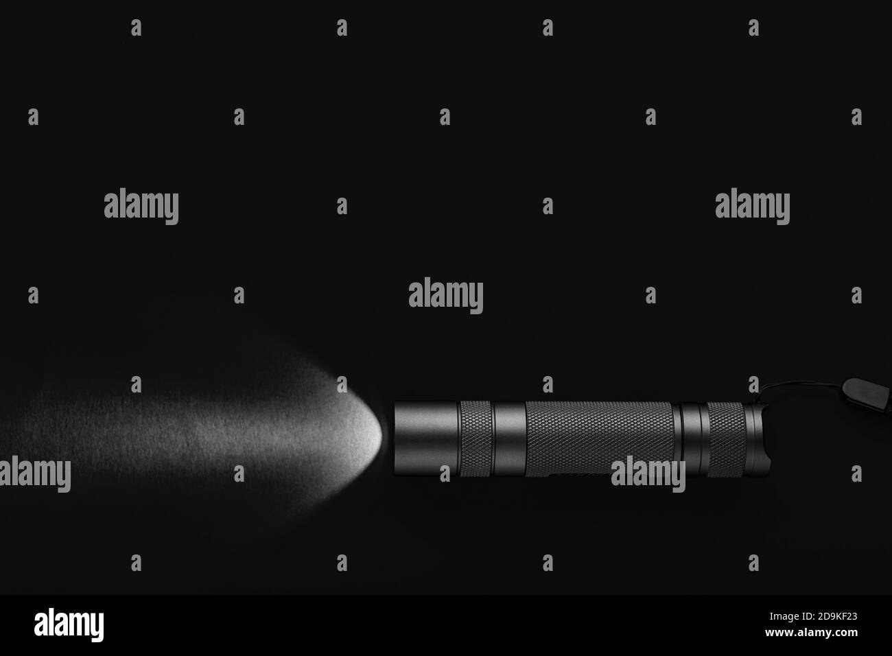 Black flashlight with a beam of light on black background Stock Photo ...