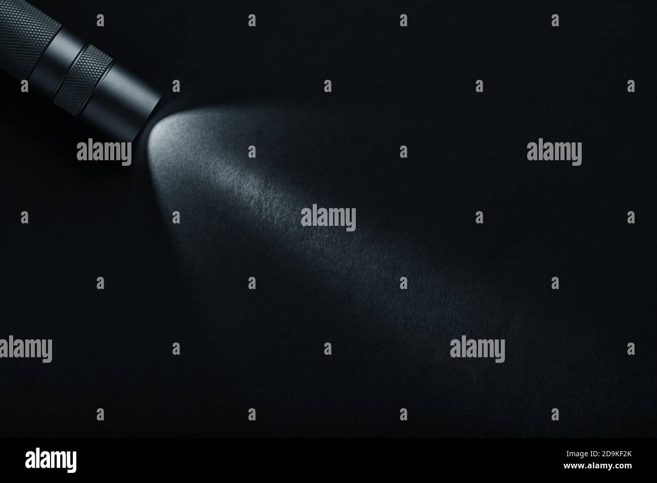 Black flashlight with a beam of light on black background Stock Photo ...