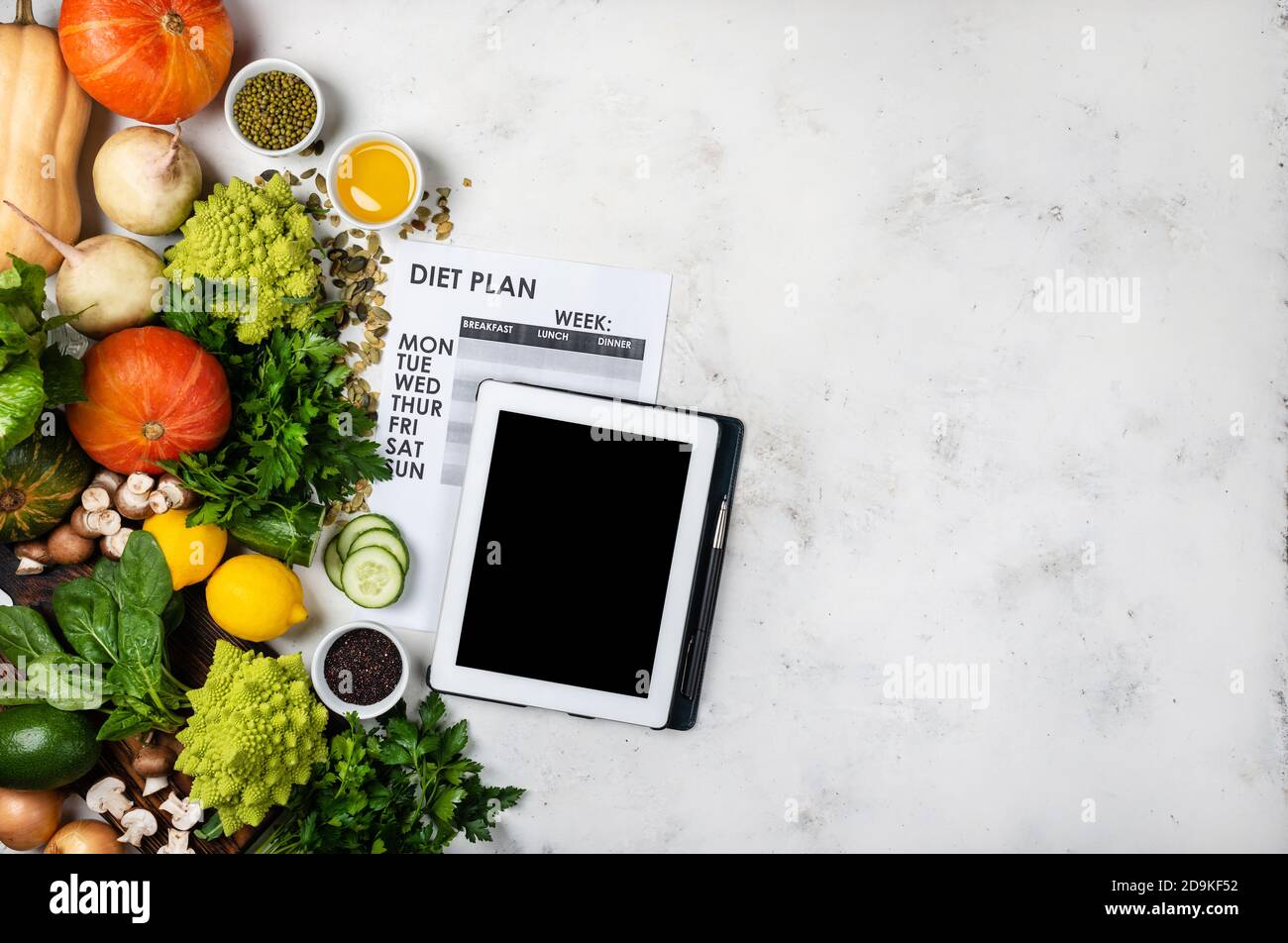 Tablet computer Diet plan and set of different vegetables and greens ...