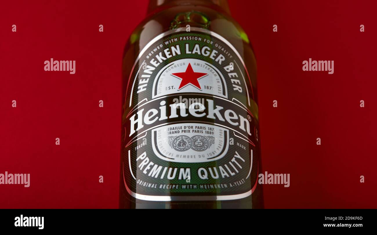Bottle of Heineken Lager Beer on red background. Heineken is the ...