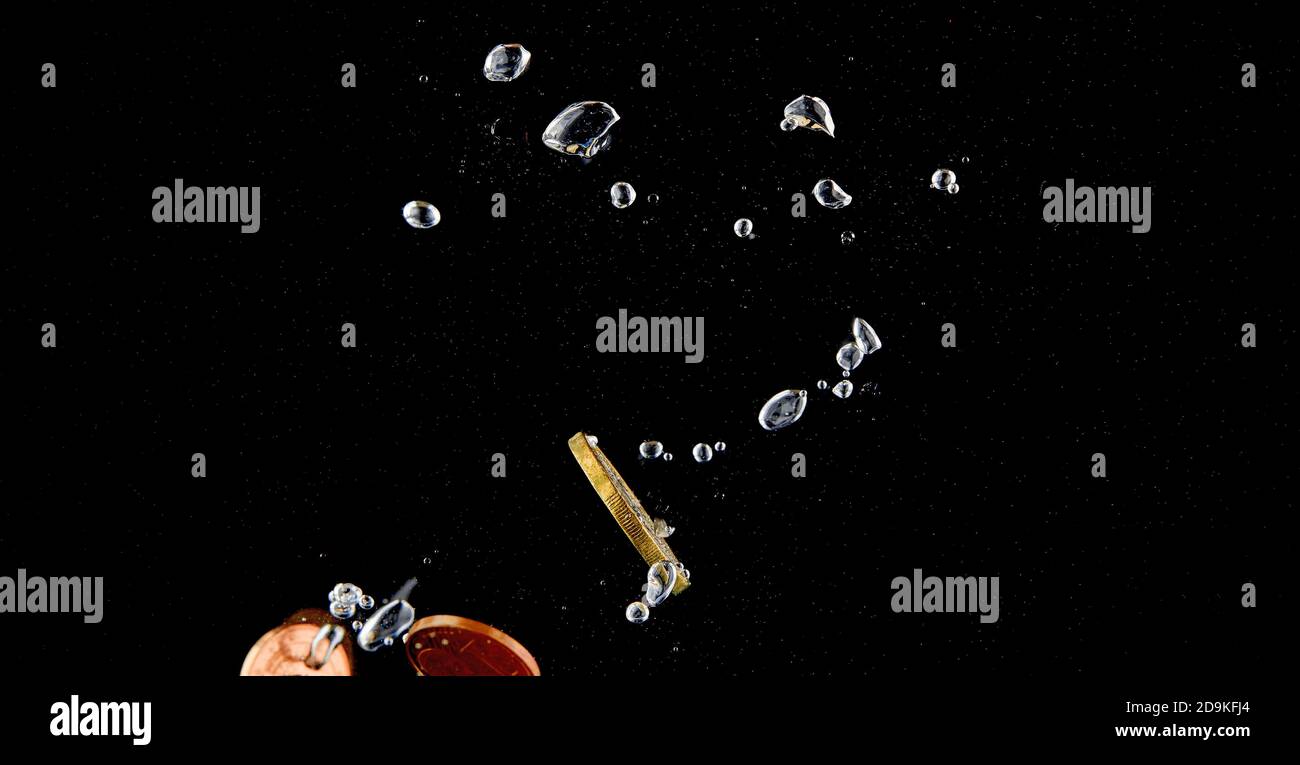 Sinking Euro. Splash of coins falling into the water. Coins in the ...