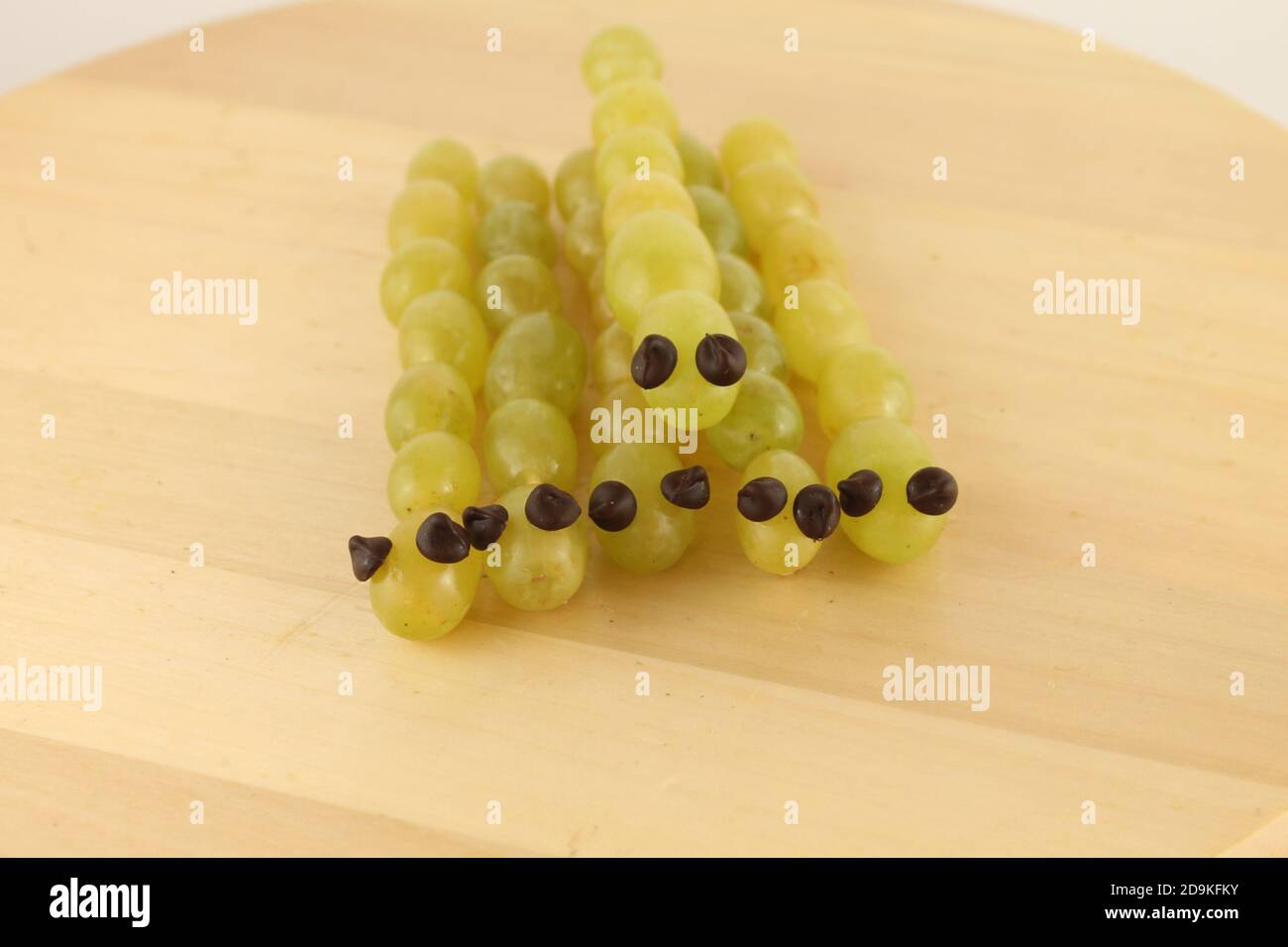 Fun party food for children. Grapes and vegan chocolate chips arrange ...
