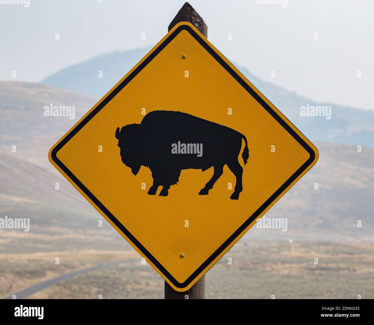 A traffic sign warning of bison on the road in Yellowstone National ...