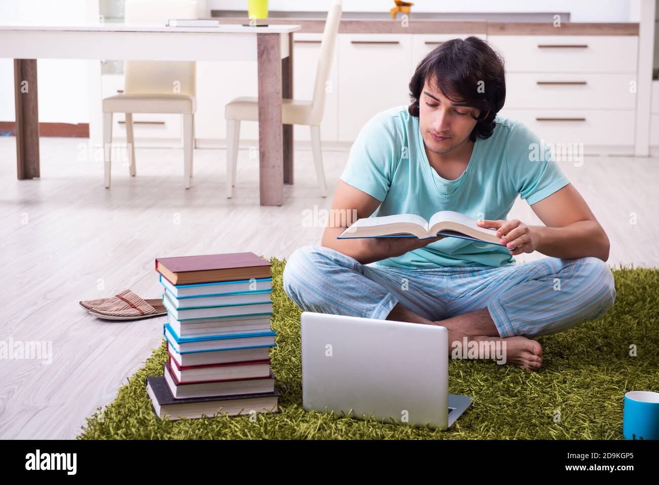 Teenager revising laptop books at home hi-res stock photography and ...