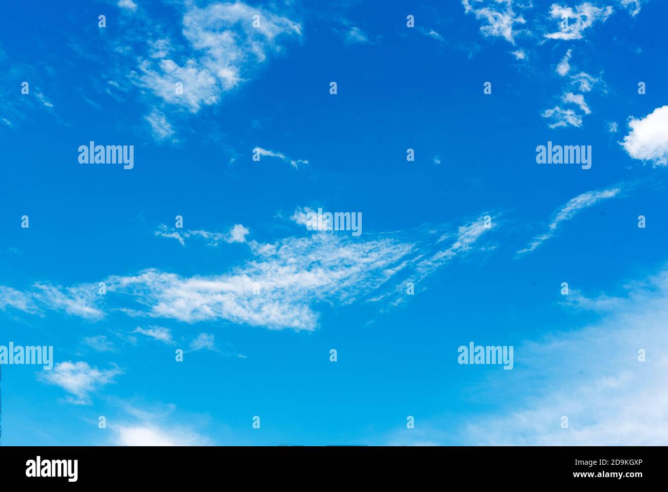 soft clouds across a bright blue sky Stock Photo - Alamy