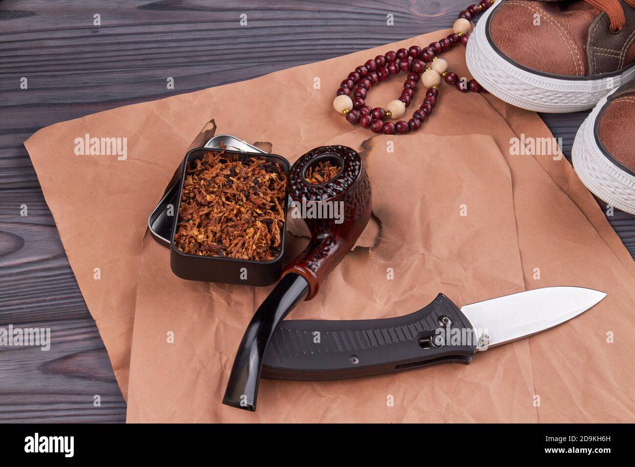 Smoking pipe with knife on beige paper Stock Photo - Alamy