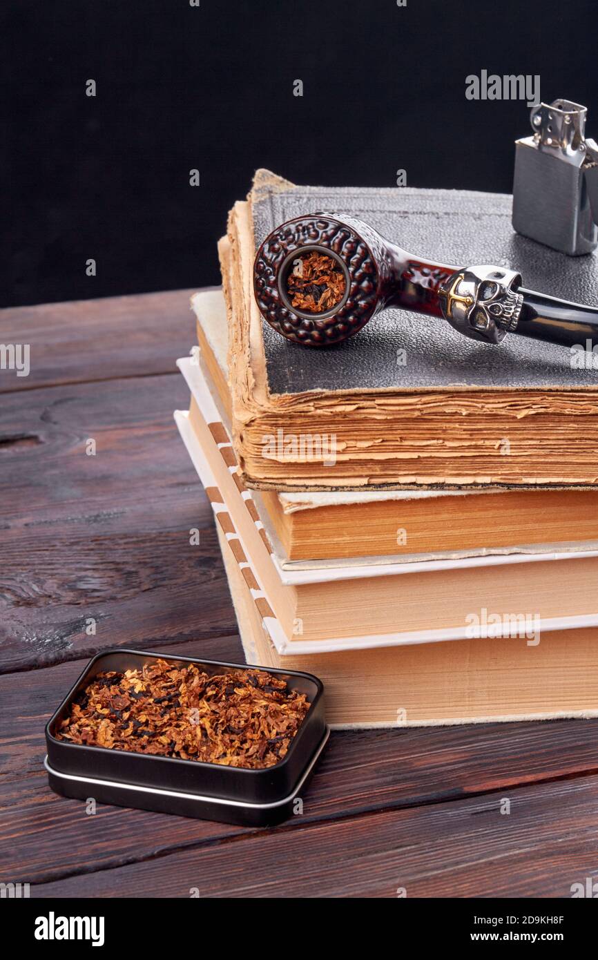 Books and pipe smoking accessories Stock Photo - Alamy