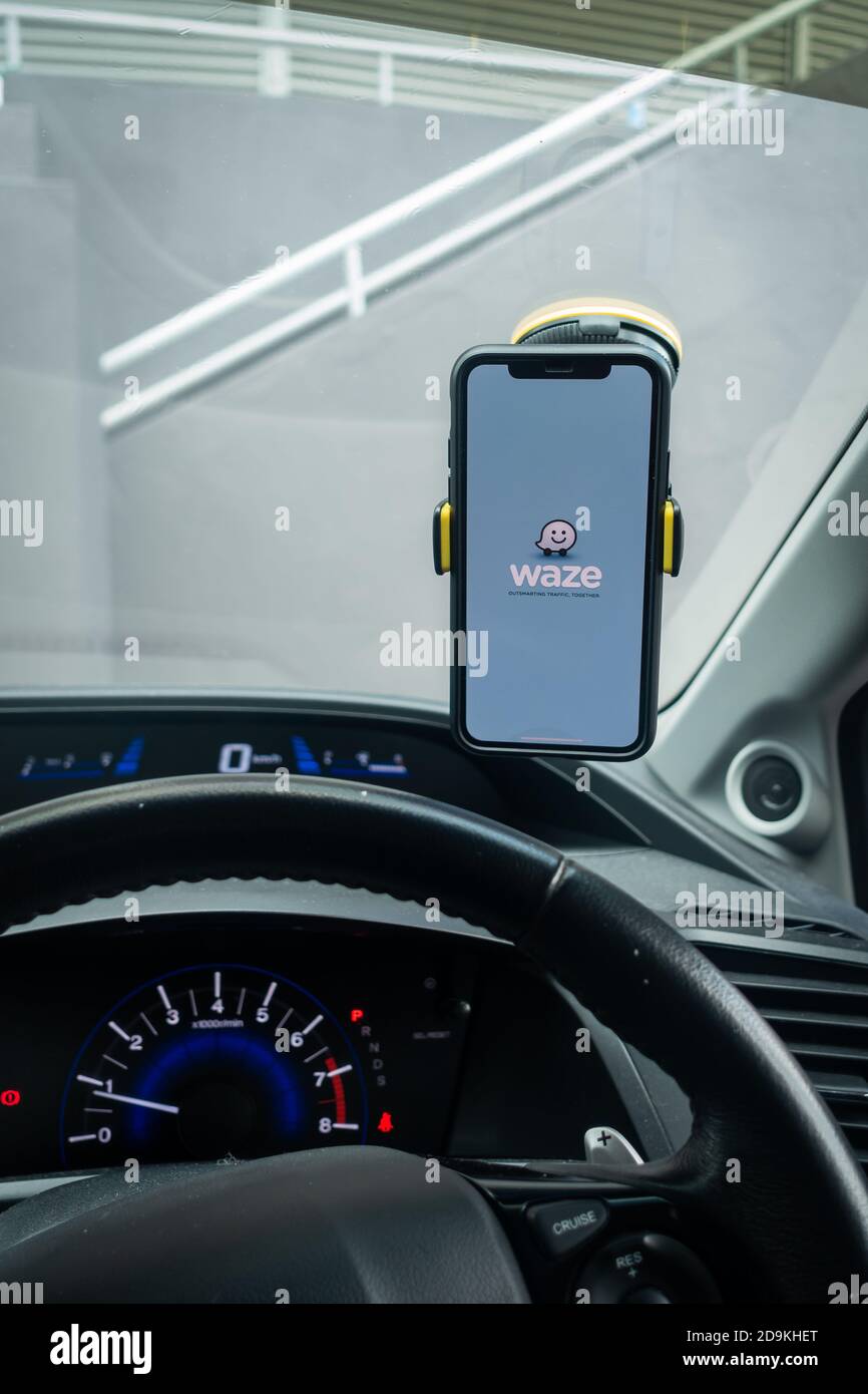 An iPhone X with Waze navigation app inside the car. Waze has gain ...
