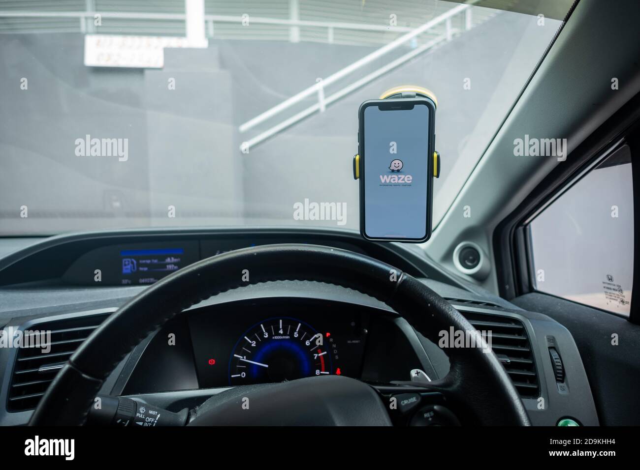 An iPhone X with Waze navigation app inside the car. Waze has gain ...