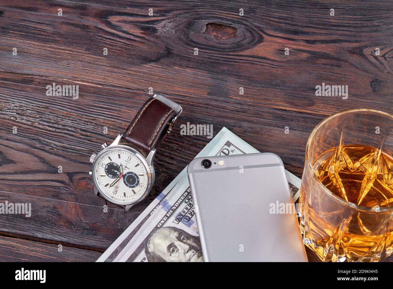 Luxury handwatch with smartphone and brandy Stock Photo - Alamy