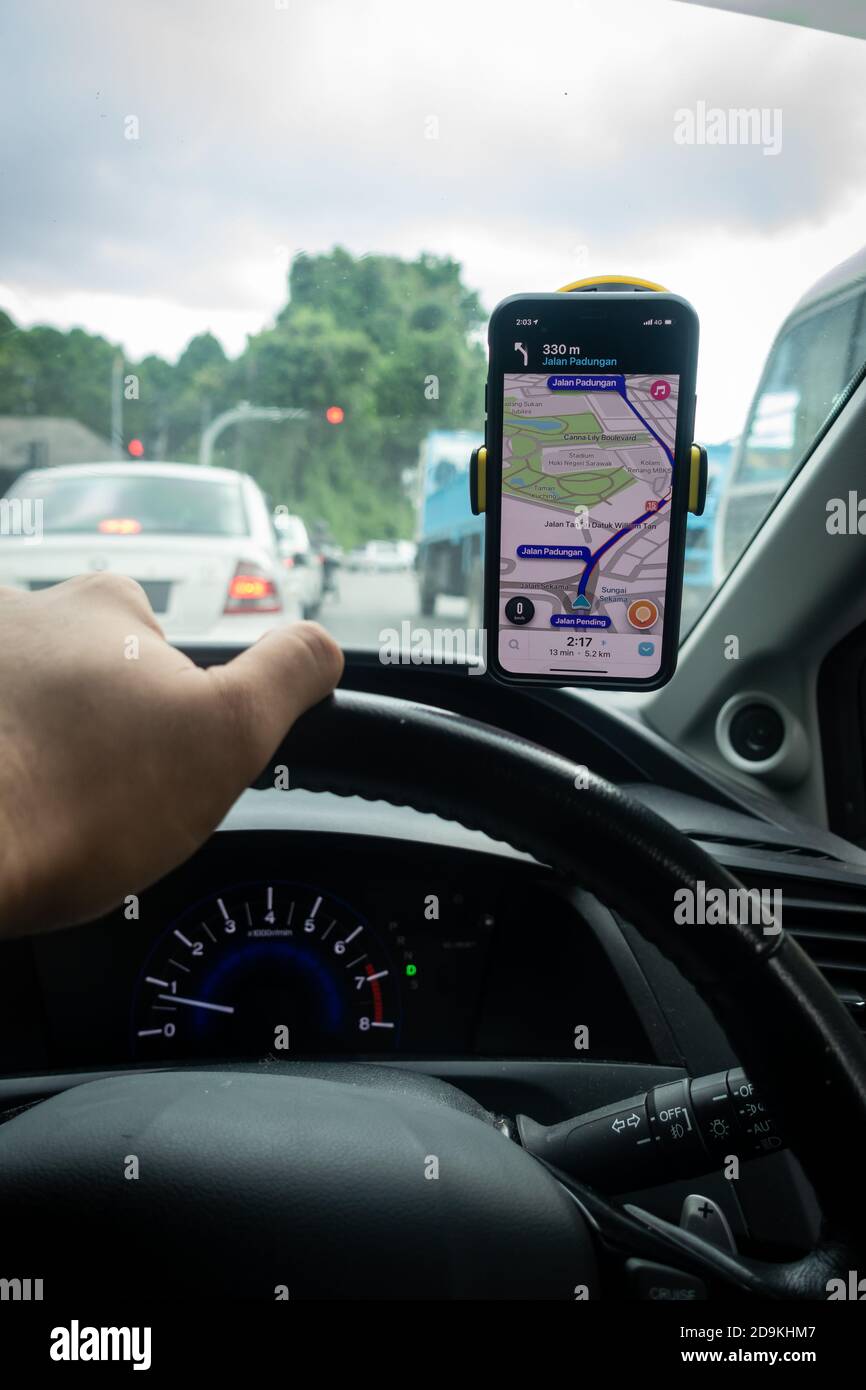 An iPhone X with Waze navigation app inside the car. Waze has gain ...