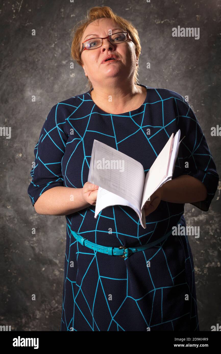 Middle aged woman accountant with papers studio portrait Stock Photo ...