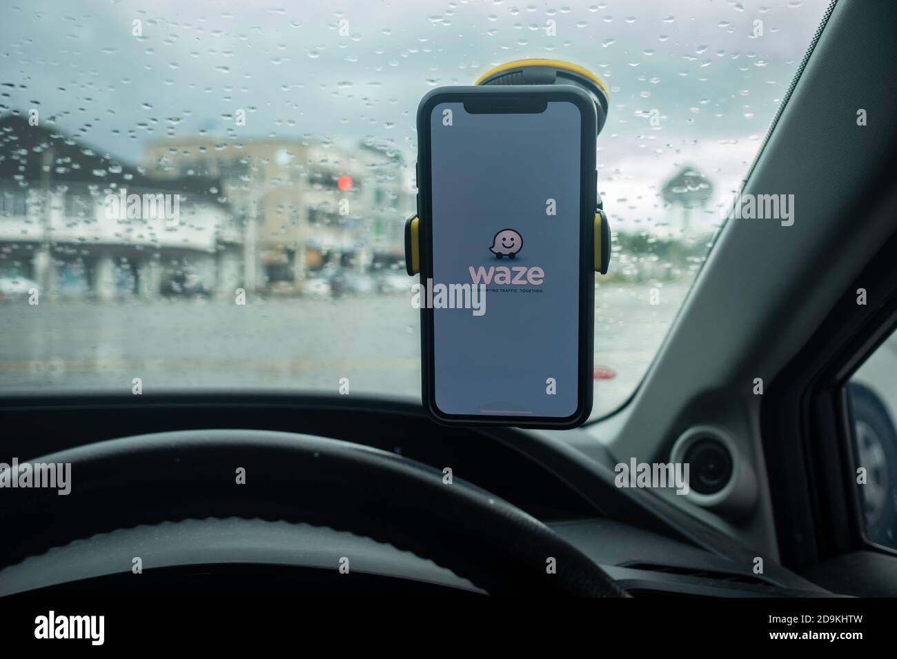 An iPhone X with Waze navigation app inside the car. Waze has gain ...