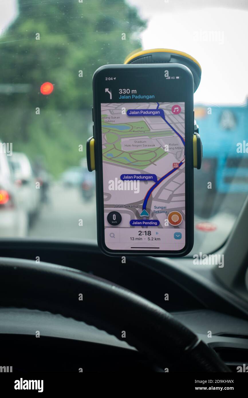 An iPhone X with Waze navigation app inside the car. Waze has gain ...