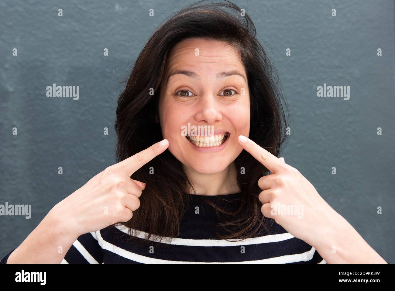 Beautiful woman pointing teeth hi-res stock photography and images - Alamy