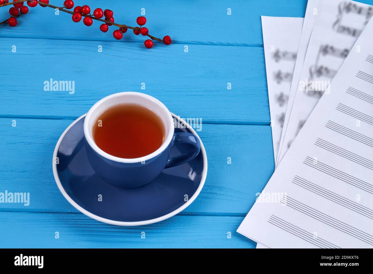 Tea cup with music notes and rowanberry Stock Photo - Alamy