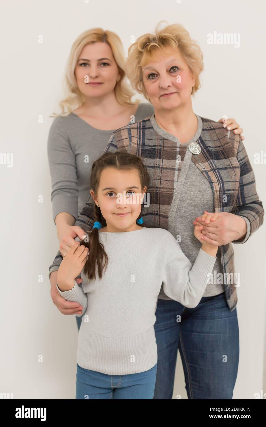 Portrait of Three generations of women of the same family isolated in ...