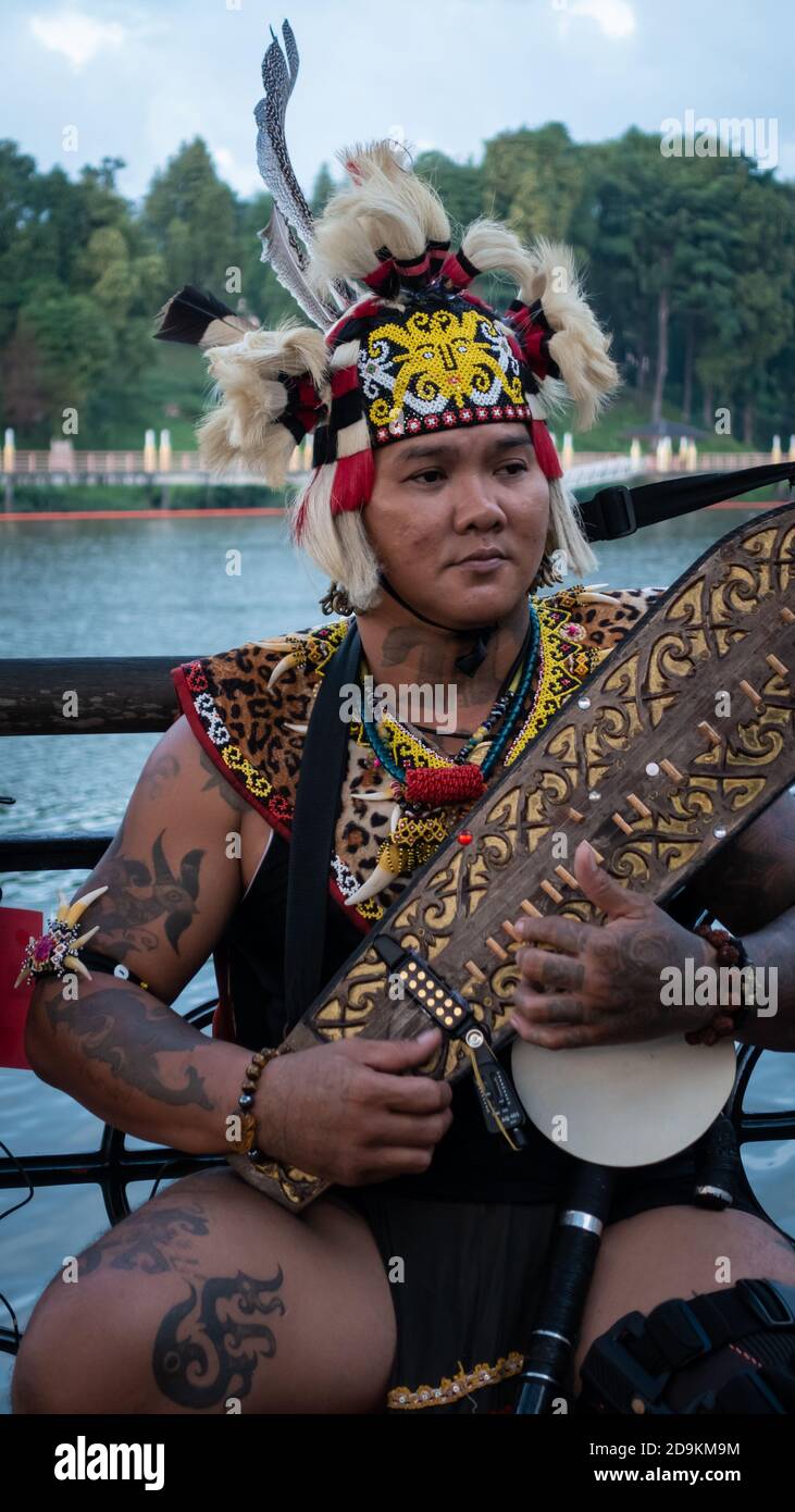 Sarawakian Man playing Sape, traditional Sarawak Musical instrument ...