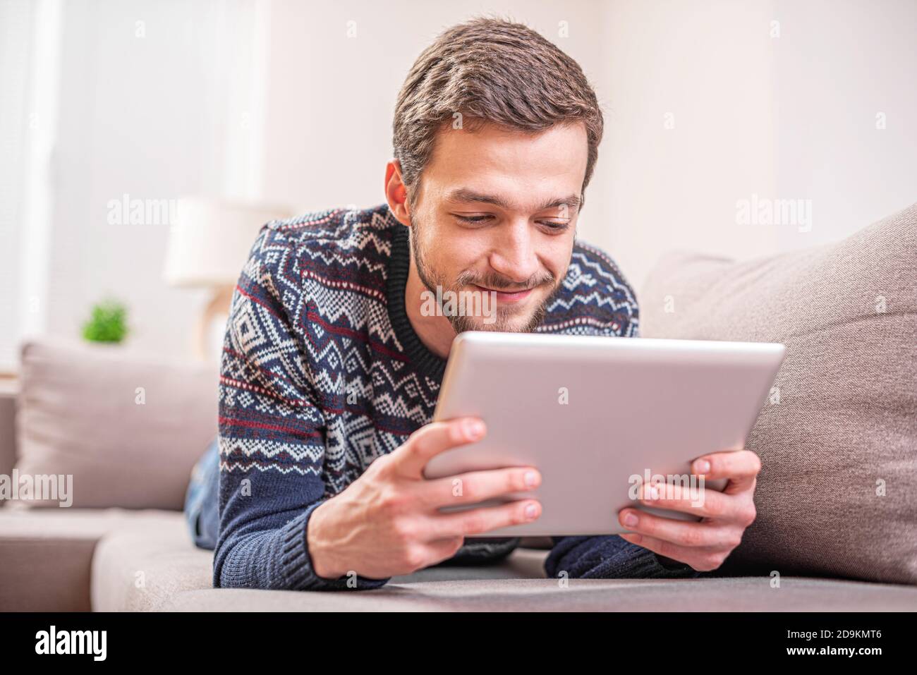 Young happy man smartphone tablet hi-res stock photography and images ...