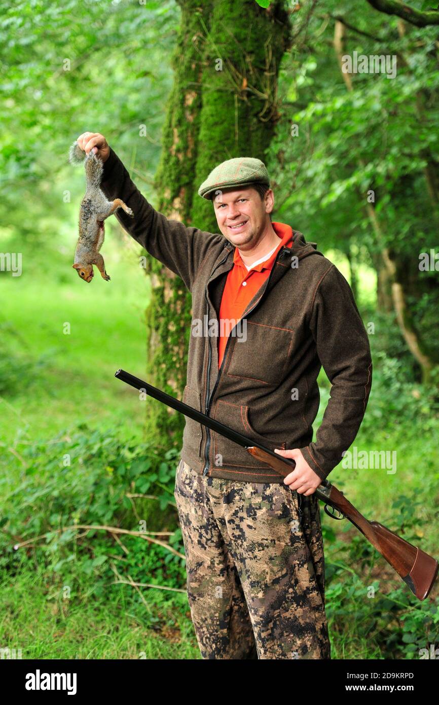 game keeper and dead squirrel Stock Photo - Alamy