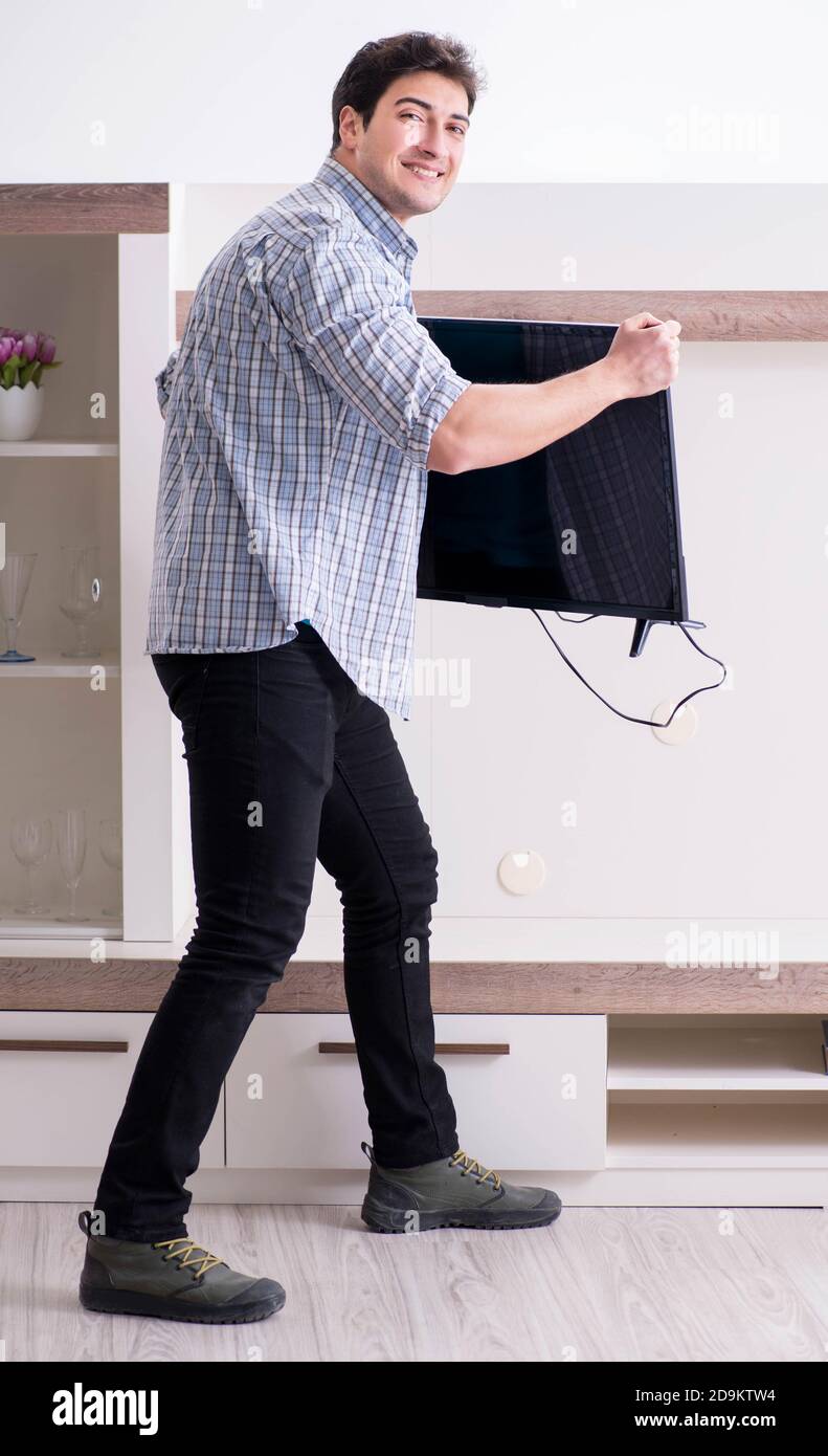 The man trying to fix broken tv Stock Photo - Alamy