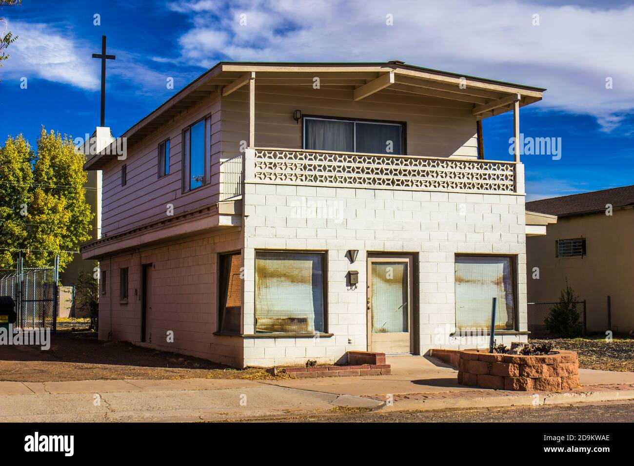 Abandoned Two Story Block Home In Back Of Church With Cross Stock Photo ...