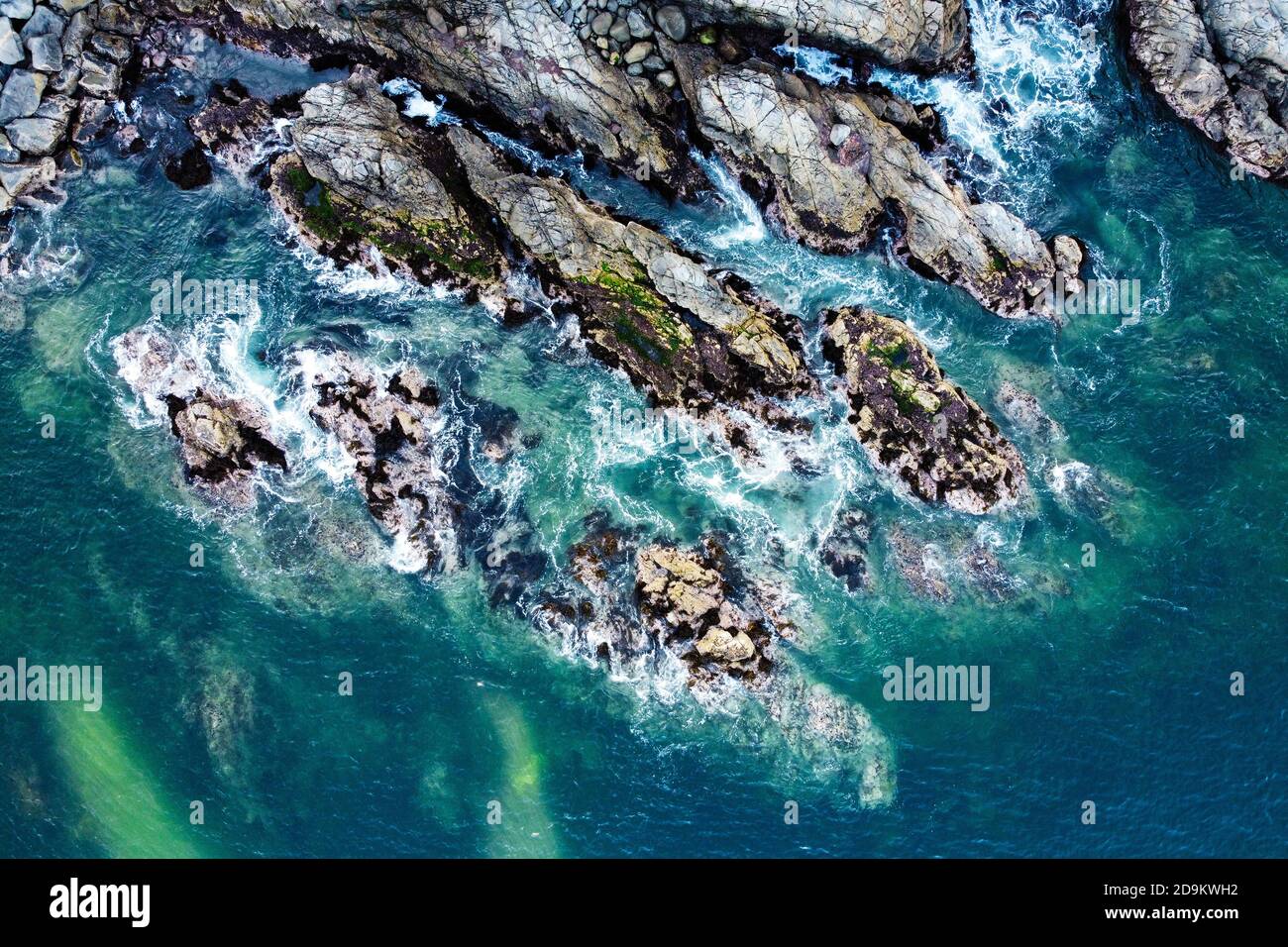 Aerial view of ocean waves and rocky coast. Danger sea waves crashing ...