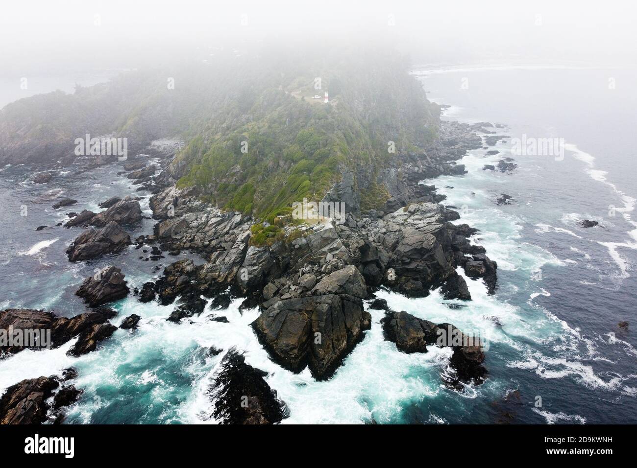 Stunning aerial view of steep cliff and lighthouse on the top of hill ...