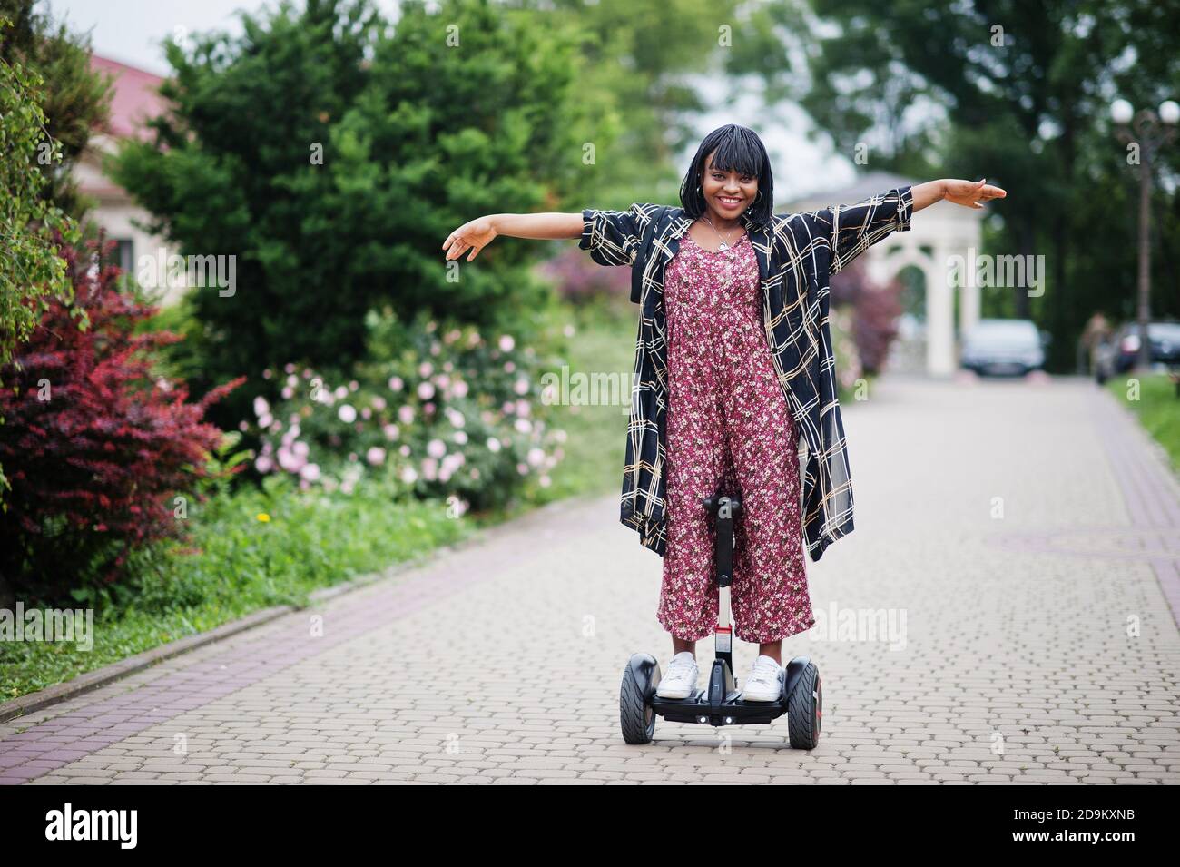 Beautiful african american woman using segway or hoverboard. Black girl ...