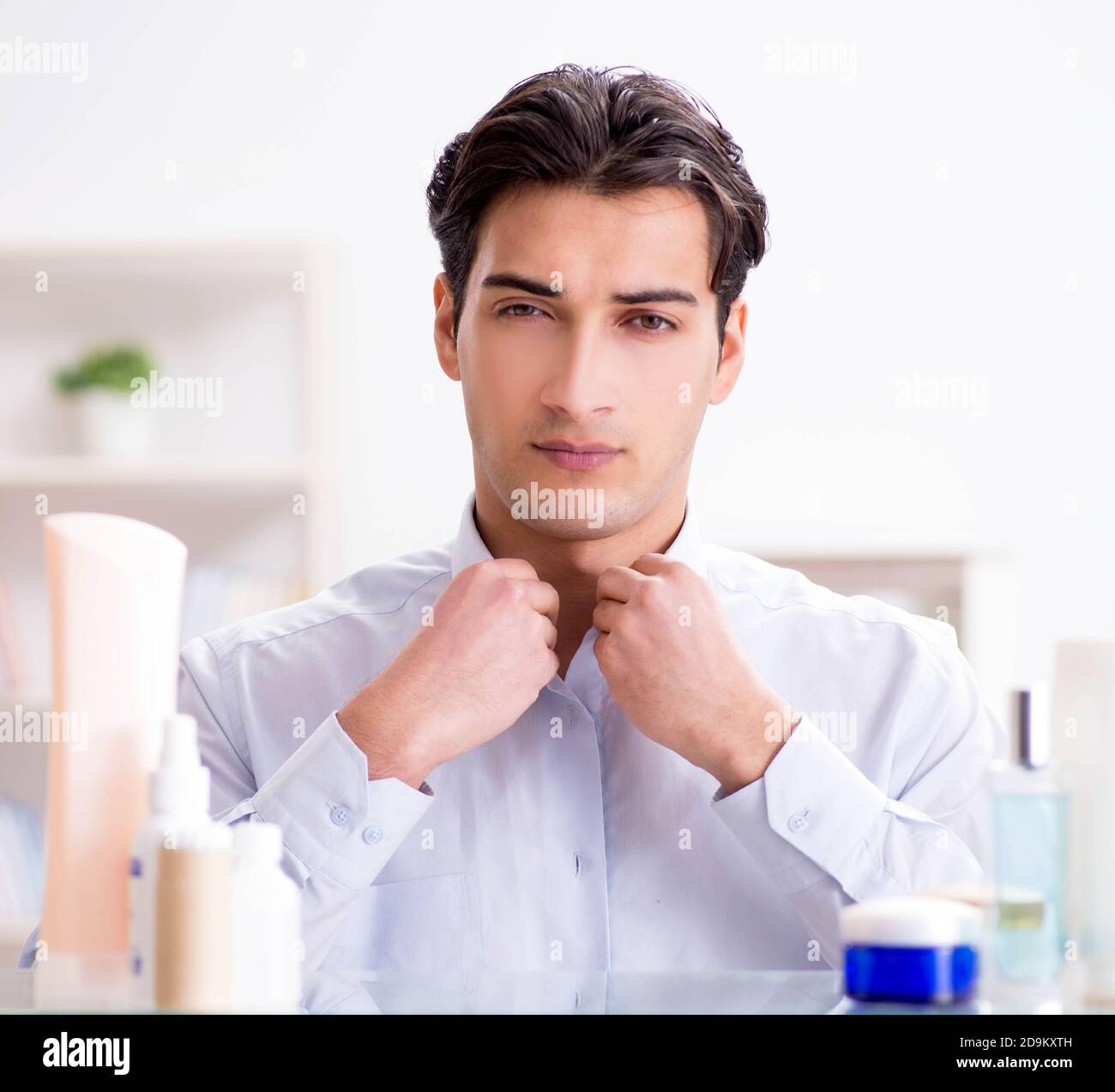 The man is getting dressed up for work in bathroom Stock Photo - Alamy