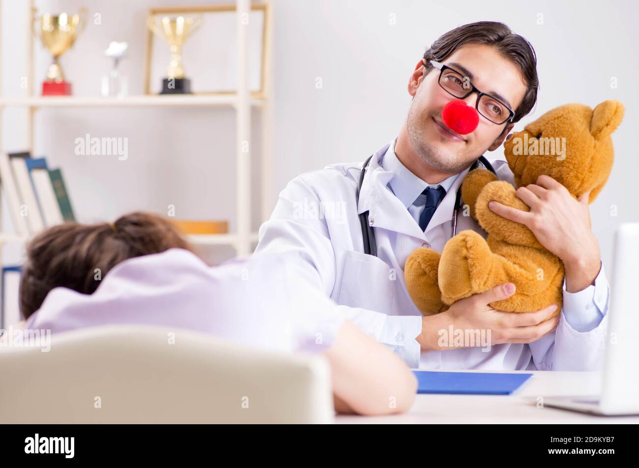The funny pediatrician with little girl at regular check-up Stock Photo ...
