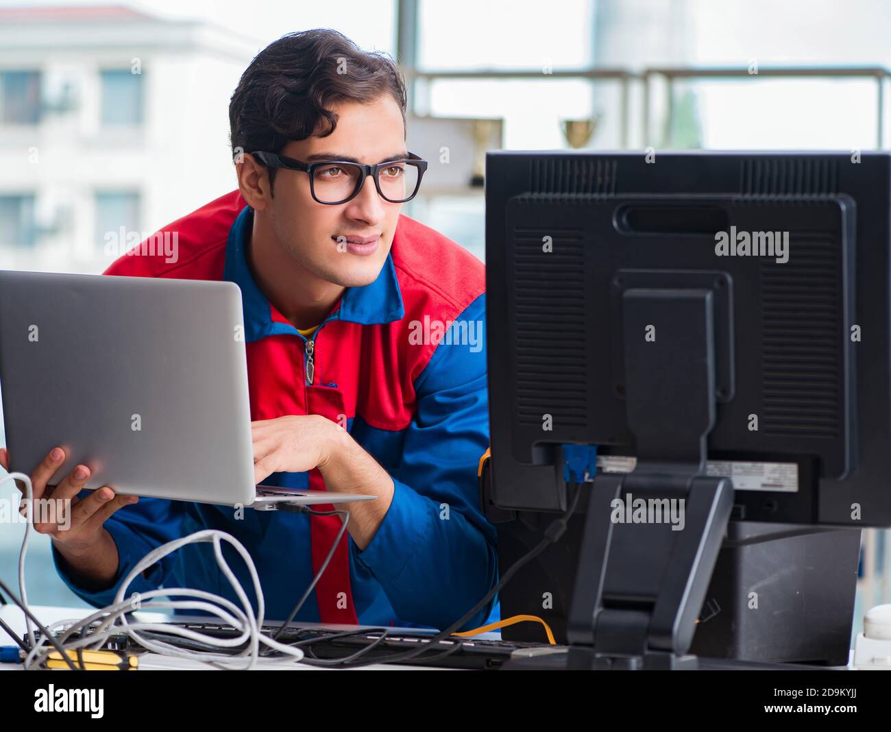 The computer repairman working on repairing computer in it workshop ...