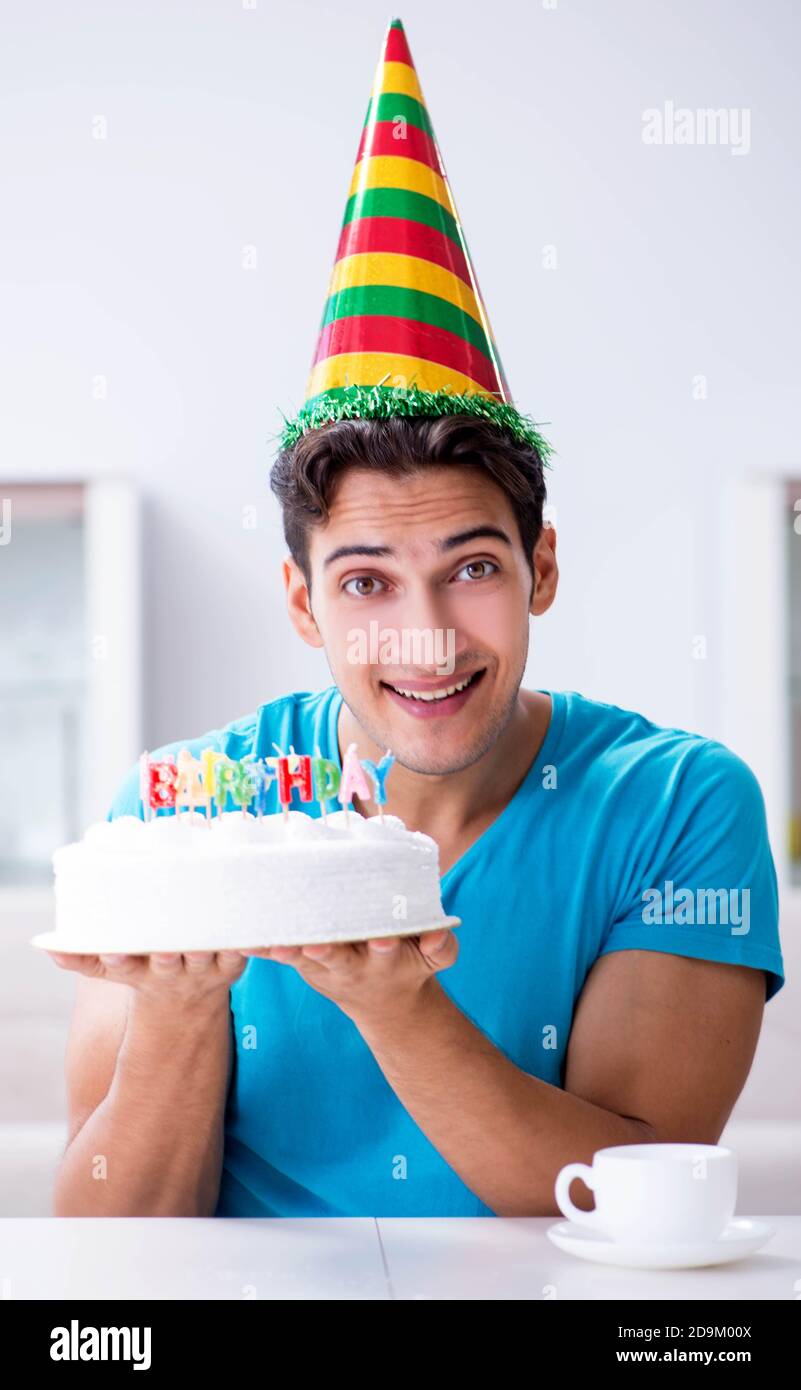 The young man celebrating birthday alone at home Stock Photo - Alamy