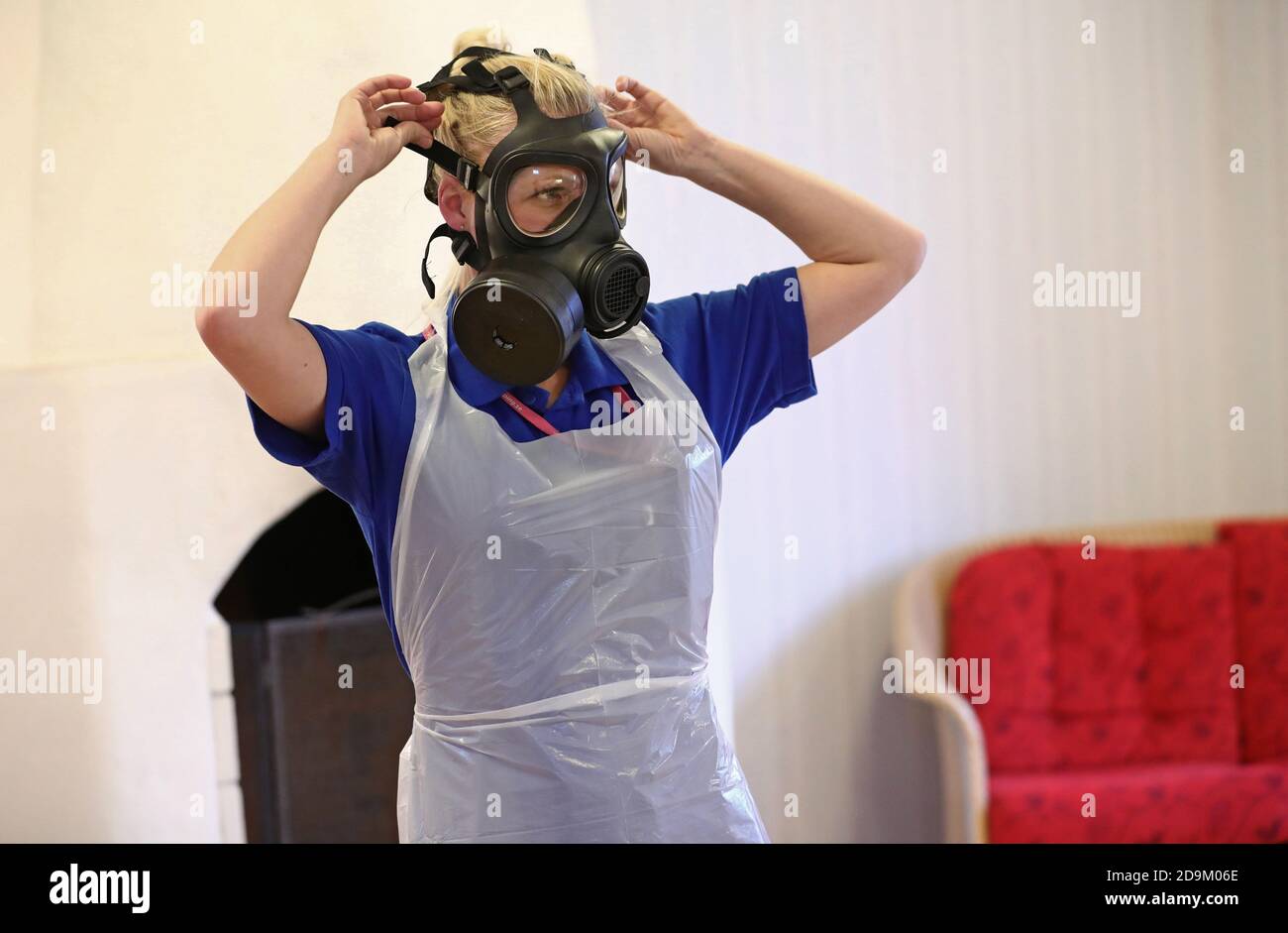 Norrköping, Sweden 20200515 Assistant nurse with gas mask, in the home ...