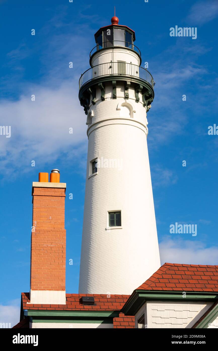 The Wind Point Lighthouse with blue skies and clouds in the background ...