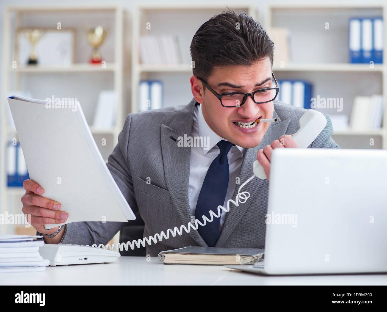 The businessman smoking in office at work Stock Photo - Alamy