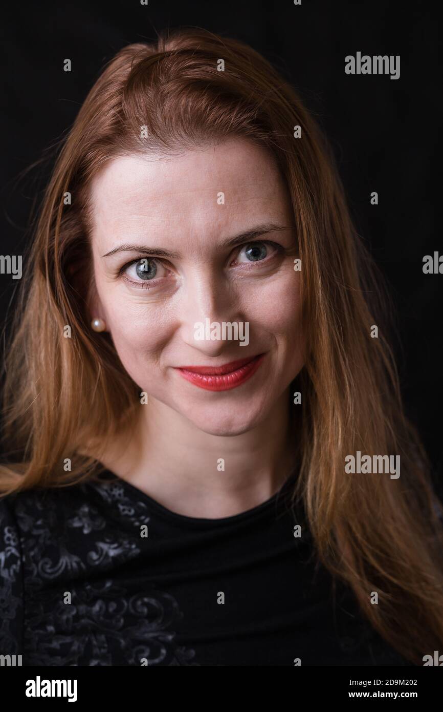 Beautiful lady with ginger hair studio portrait on black background ...