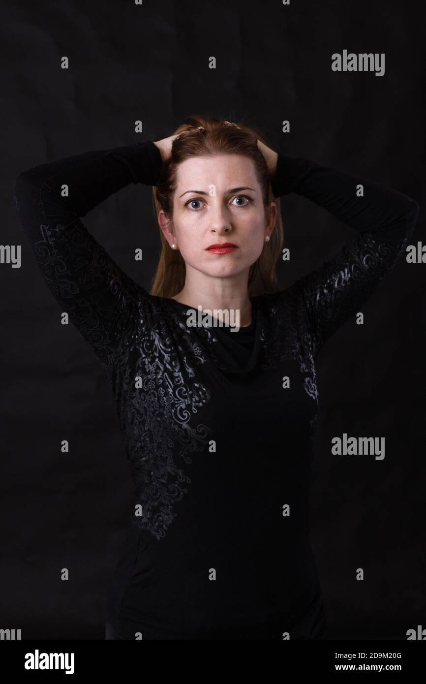 Beautiful lady with ginger hair studio portrait on black background ...