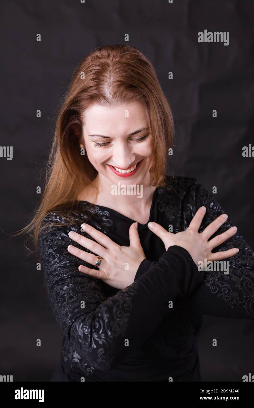 Beautiful lady with ginger hair studio portrait on black background ...
