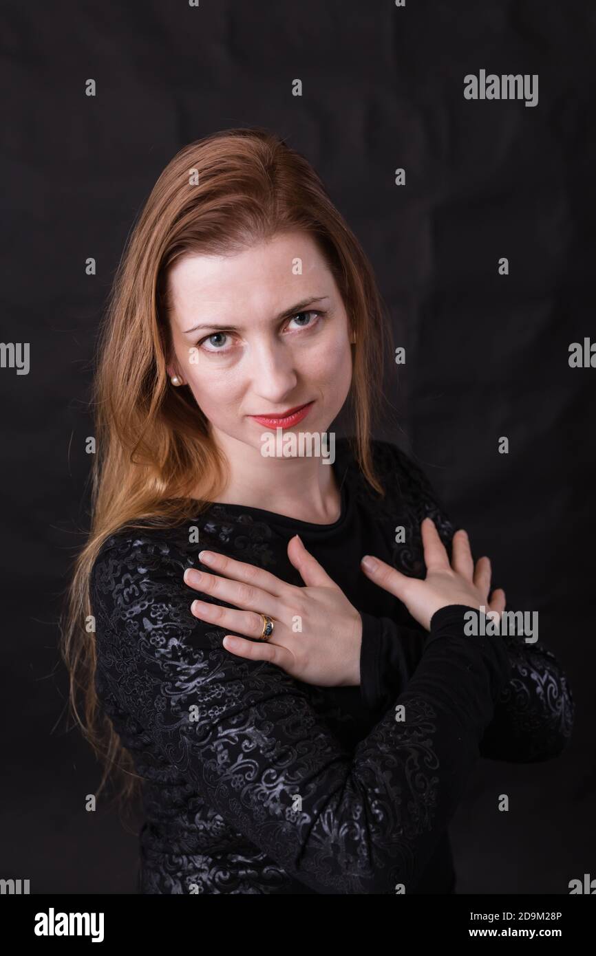 Beautiful lady with ginger hair studio portrait on black background ...