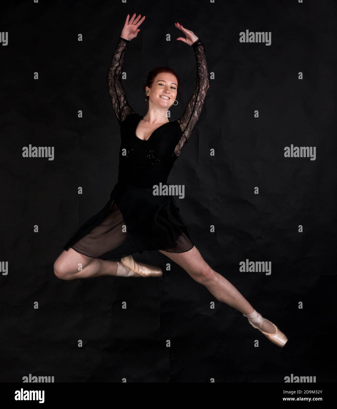 Beautiful dancer studio portrait jumping on black background Stock ...