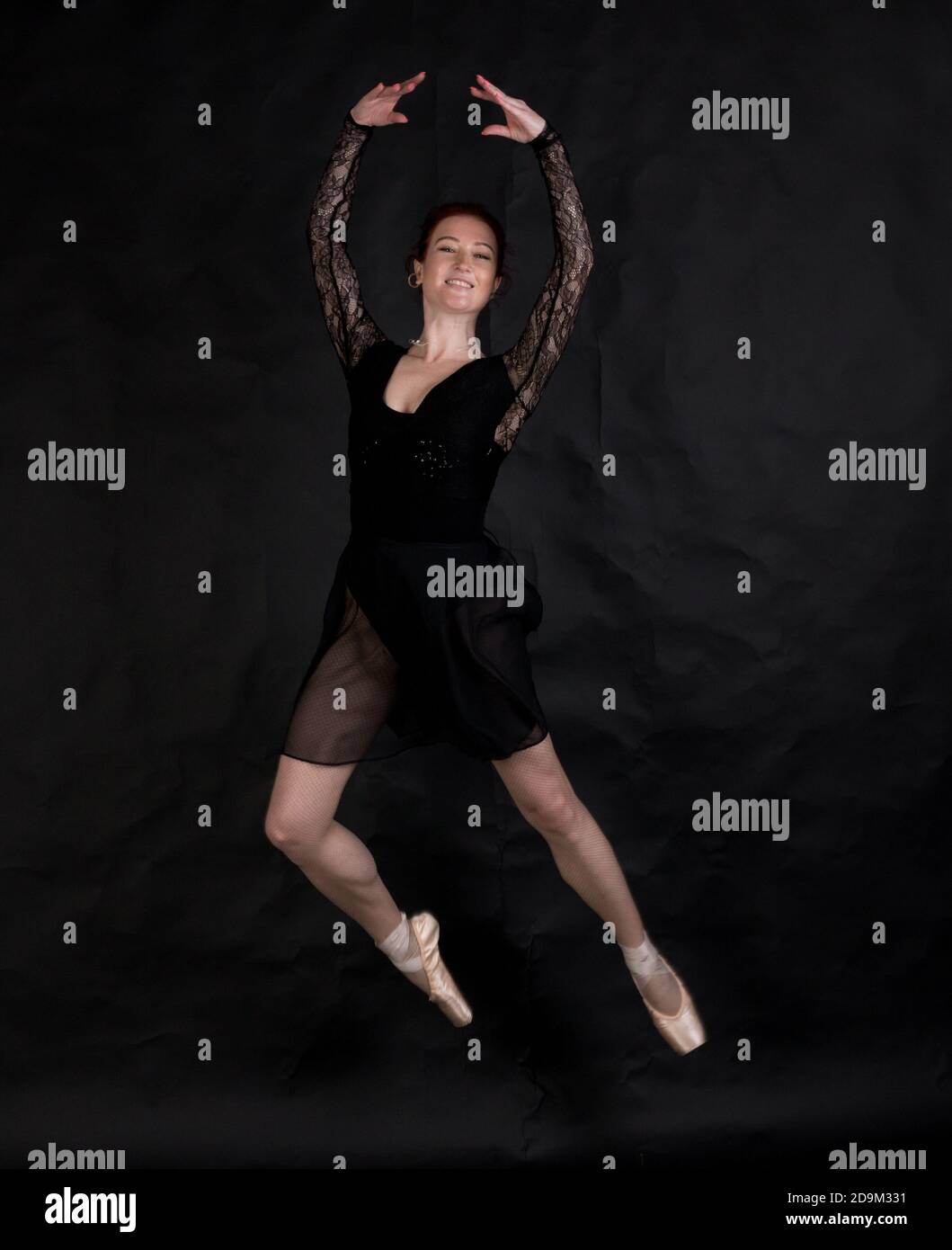 Beautiful dancer studio portrait jumping on black background Stock ...